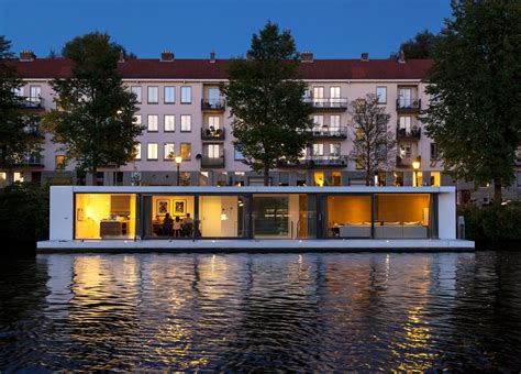 floating home by 31 architects moored on amsterdam river