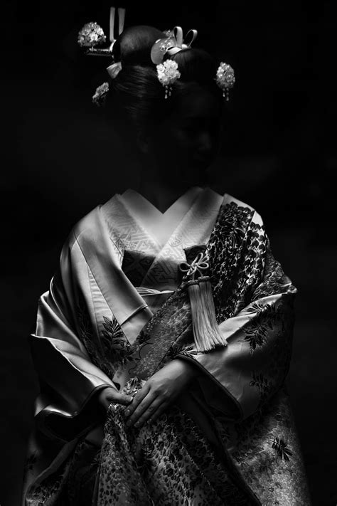 Download Traditional Japanese Geisha In A Dark Setting Wallpaper