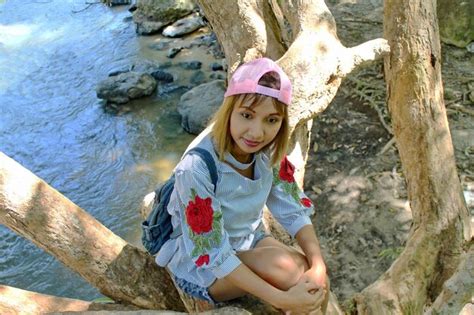 Premium Photo Portrait Of Smiling Girl Sitting Outdoors