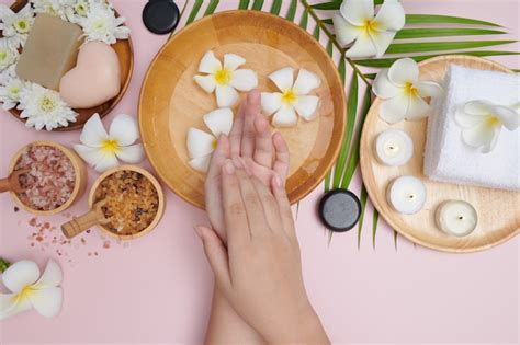 Free Photo Woman Soaking Her Hands In Bowl Of Water And Flowers Spa