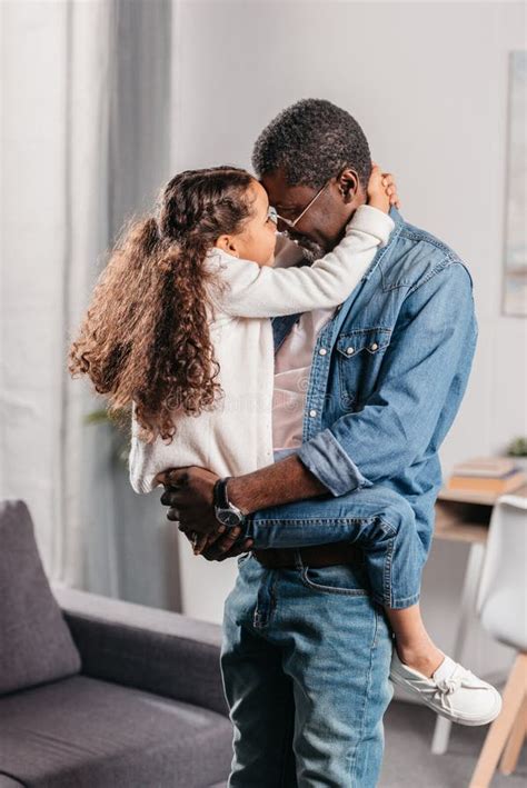 Loving African American Girl Embrace Father That Holding Her Stock