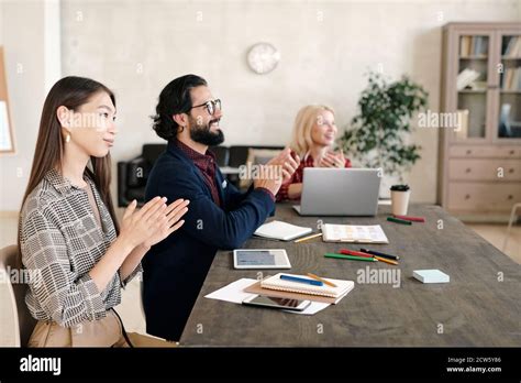 Three Contemporary Intercultural Professionals Clapping Their Hands