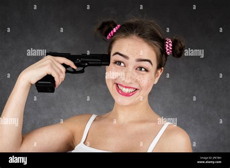 Fun Crazy Girl Teenager Shooting Herself On Black Background Stock