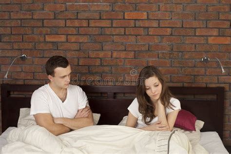 Young Couple Sitting On The Bed Because Of Relationship Difficulties