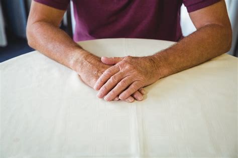 Premium Photo Senior Man Sitting At A Table