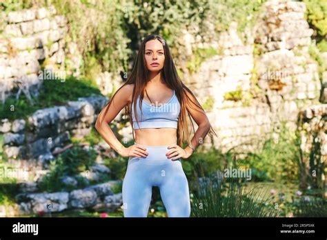 Portrait Of Young Beautiful Fit Woman Stretching Outside Wearing