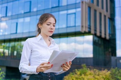 Elegant Caucasian Business Woman In Formal Wear Holds Paper Documents