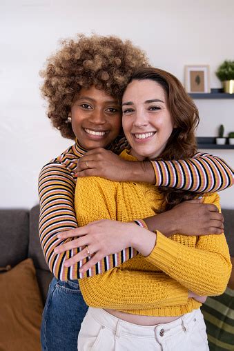 Close Up Of Beautiful And Cheerful Multiracial Lesbian Couple Hugging
