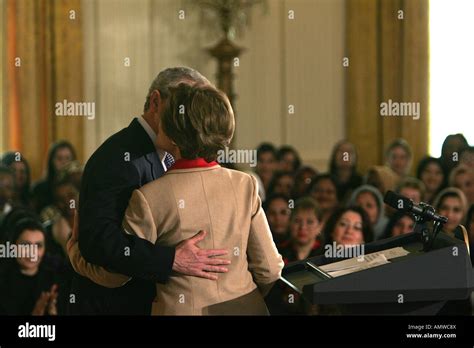 President George W Bush And First Lady Laura Bush Kiss During A