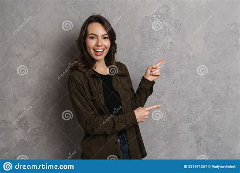 Happy Beautiful Brunette Girl Smiling And Pointing Fingers Aside Stock