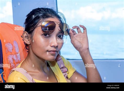 Woman With Sunglasses Sit On A Ship Beside Window With View At The Sea