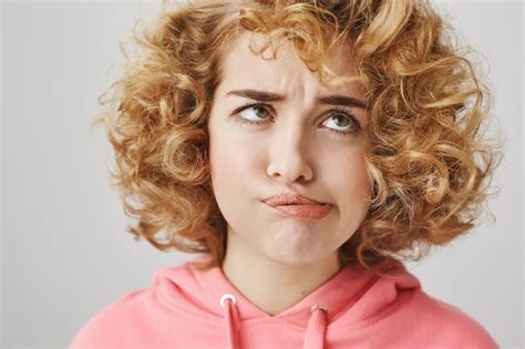 Free Photo Funny Curly Haired Grimacing Girl Making Faces And Squinting