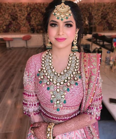 A Woman In A Pink Outfit With Jewelry On Her Head