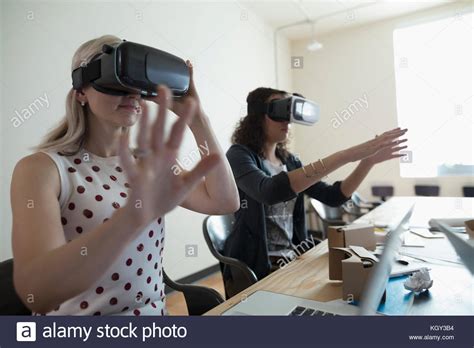 female computer programmer designers testing virtual reality simulator