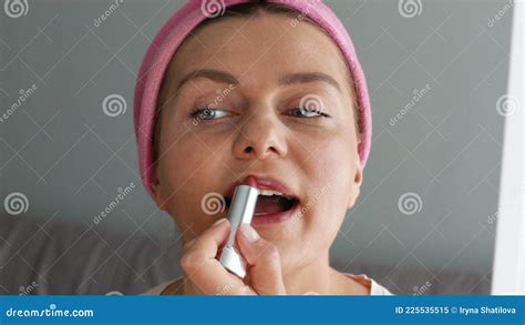 Happy Beautiful Millennial Girl Putting On Lipstick Rouging Lips