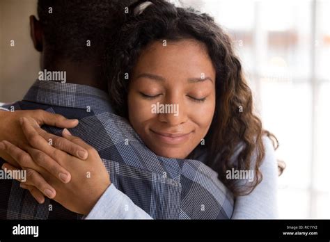 Happy African American Wife Hugging Husband Holding Tight Feelin Stock