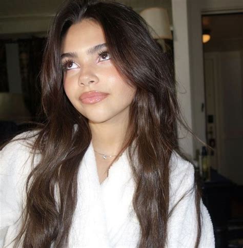 A Woman With Long Brown Hair Wearing A White Robe