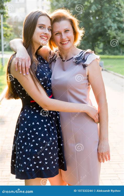 Closeup Portrait Of Adult Daughter And Mother Outdoors Pretty Brunette