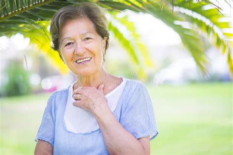 Smiling Middle Aged Mature Grey Haired Woman Looking At Camera Happy