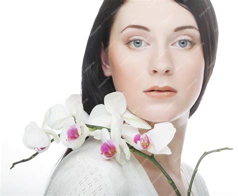 Premium Photo Woman With Orchid Flower Over White Background