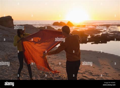 Happy Adult Caucasian Couple Having Fun On The Beach Hi Res Stock
