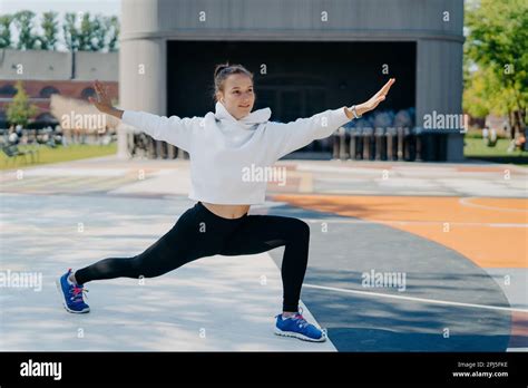 Active Young Woman Dedicated To Fitness Does Stretching Exercises