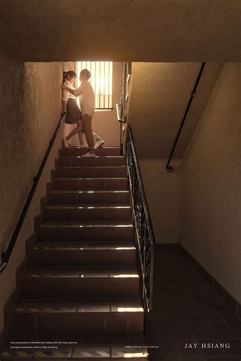 Two People Walking Up Some Stairs With Their Arms Around Each Other And