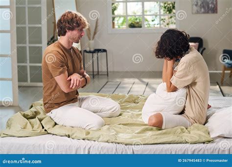 Young Woman With Pillow Covering Her Face While Sitting In Front Of Her