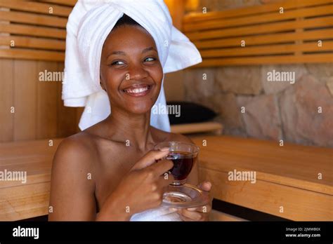 African American Woman In A Bathrobe Holding A Tea Cup Relaxing In The