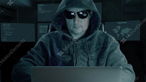 hacker typing at laptop man coding on computer dark night man in dark