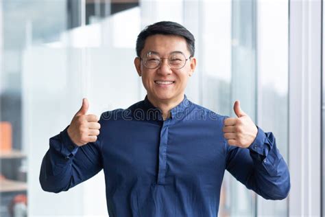 Portrait Of Successful Asian Man Inside Office Near Window Boss In