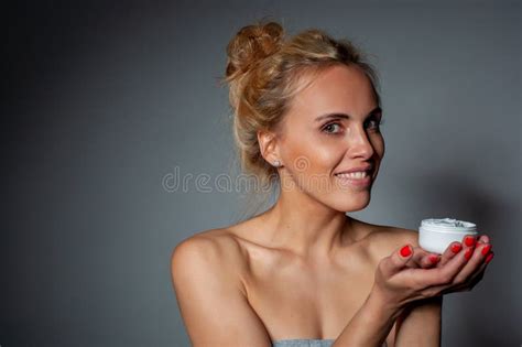 Horizontal Closeup Portrait Of A Smiling Blonde With Bare Shoulders