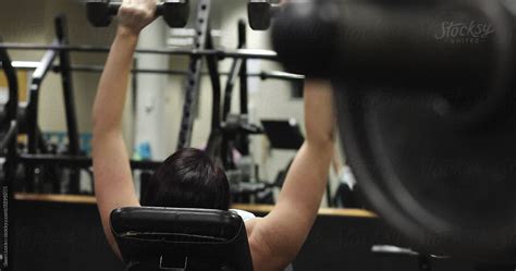 "Gym: Woman Working Arms On Bench" by Stocksy Contributor "Sean Locke ...