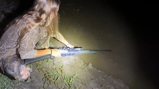 Watch this woman hunt giant frogs with rifle at night