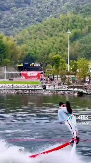 Woman soars above lake with water-powered jetpack