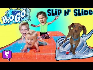 GIANT SLIP N SLIDE with SURPRISE TOYS by the Water with HobbyKidsTV! - Videos For Kids