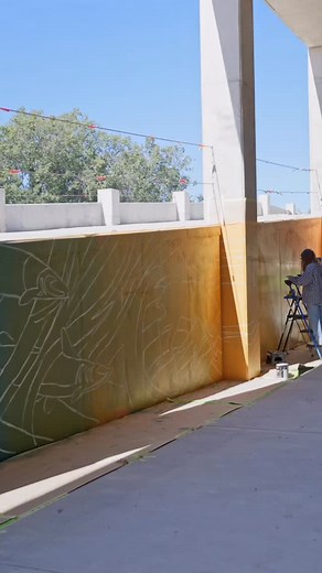 Once projection tracing is complete, the fresh lines on the gradient-colored walls give us an idea of what we can look forward to filling in and bringing even further to life! The muralists are given color-by-letter templates to start painting sections with correspondingly labeled paint cans. More details emerge as our massive mural rewards us with a hint of what’s to come. | Emmett Joseph Photography