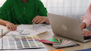 Interior designer drafting blueprint with customer supervise and oversee interior designer draw house room layout on home based on client demand. Architectural customer service. Variegated