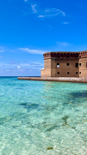 If getting there is half the adventure, 𝗗𝗿𝘆 𝗧𝗼𝗿𝘁𝘂𝗴𝗮𝘀 𝗡𝗮𝘁𝗶𝗼𝗻𝗮𝗹 𝗣𝗮𝗿𝗸 might be the ultimate destination! 🪸🐠 Located roughly 70 miles west of Key West, it’s the 𝘮𝘰𝘴𝘵 𝘳𝘦𝘮𝘰𝘵𝘦 national park in the continental U.S., and definitely one of the most unforgettable. Home to Civil War-era Fort Jefferson, a vibrant coral reef just off the beach, and nesting seabirds you won’t find many other places, the Dry Tortugas are unlike any other place. The park is only accessible by b