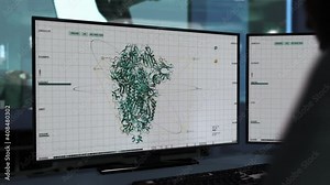 Scientist is sitting in front a computer. Two computer screens and a keyboard on desk. Biomedical software. 3D model analysis of a Covid-19 spike protein structure. Bright background. User interface.