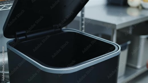 Sensor activated smart waste disposal system opens in professional commercial kitchen promoting hygiene and efficiency