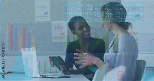 Woman in blazer showing tablet while peer gesturing, tapping tablet causing business chart overlays