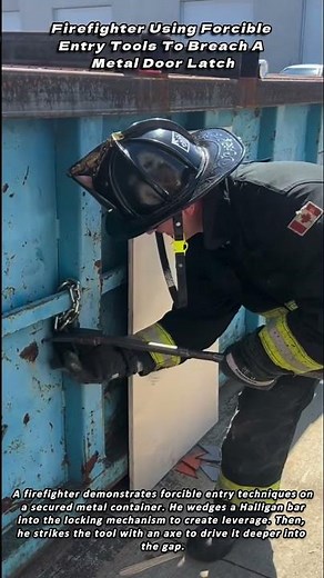 Firefighter Using Forcible Entry Tools To Breach A Metal Door Latch