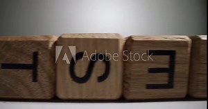 Line made of wooden cubes with letters of English alphabet. Incorrectly inverted blocks with ABC letters stand on white surface in wrong order