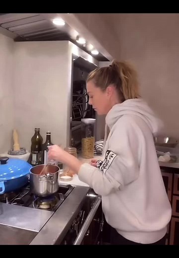 Cooking and Dance Routine in a Stylish Kitchen