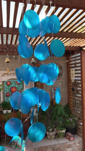 🌊💙 Bring the sound of the sea to your garden! This blue capiz shell wind chime shimmers like ocean waves and sings the sweetest coastal melody when the breeze rolls through. Perfect for adding a touch of beachy bliss to your patio, porch, or garden oasis. ☀️🐚 Let it sparkle in the sun and fill your space with peaceful seaside vibes — every shell tells a little ocean story. 🌴✨ #BeachVibes #CoastalDecor #CapizShellWindChime #OceanInspired #GardenDecor #BeachHouseStyle #SoothingSounds #TikTokSh