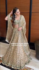 Cream color wedding lehenga with stones and emerald pearls