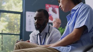 Specialist measuring sugar level with blood sample to do insulin test with medical glucometer for asian patient with diabetes. African american medic checking glucose at examination in hospital lobby
