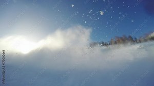 Extreme skier spraying snow in slow motion in sunny mountain with bokeh and lens flare effects. 1920x1080