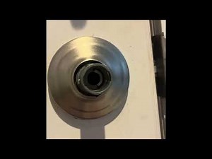 Removing a door handle with no visible screws.